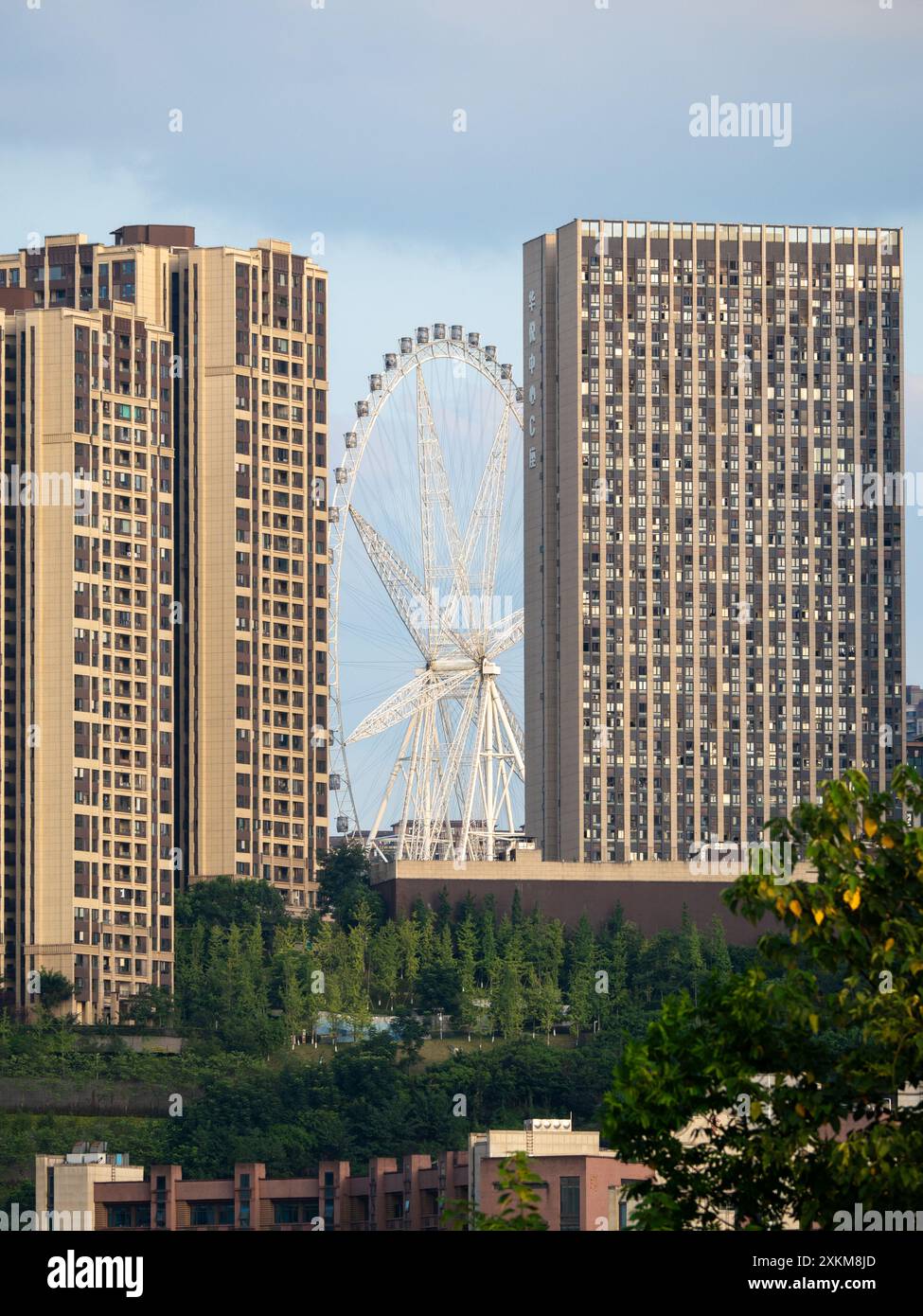 Ferris wheel visible between the gap of two high rise buildings Stock ...