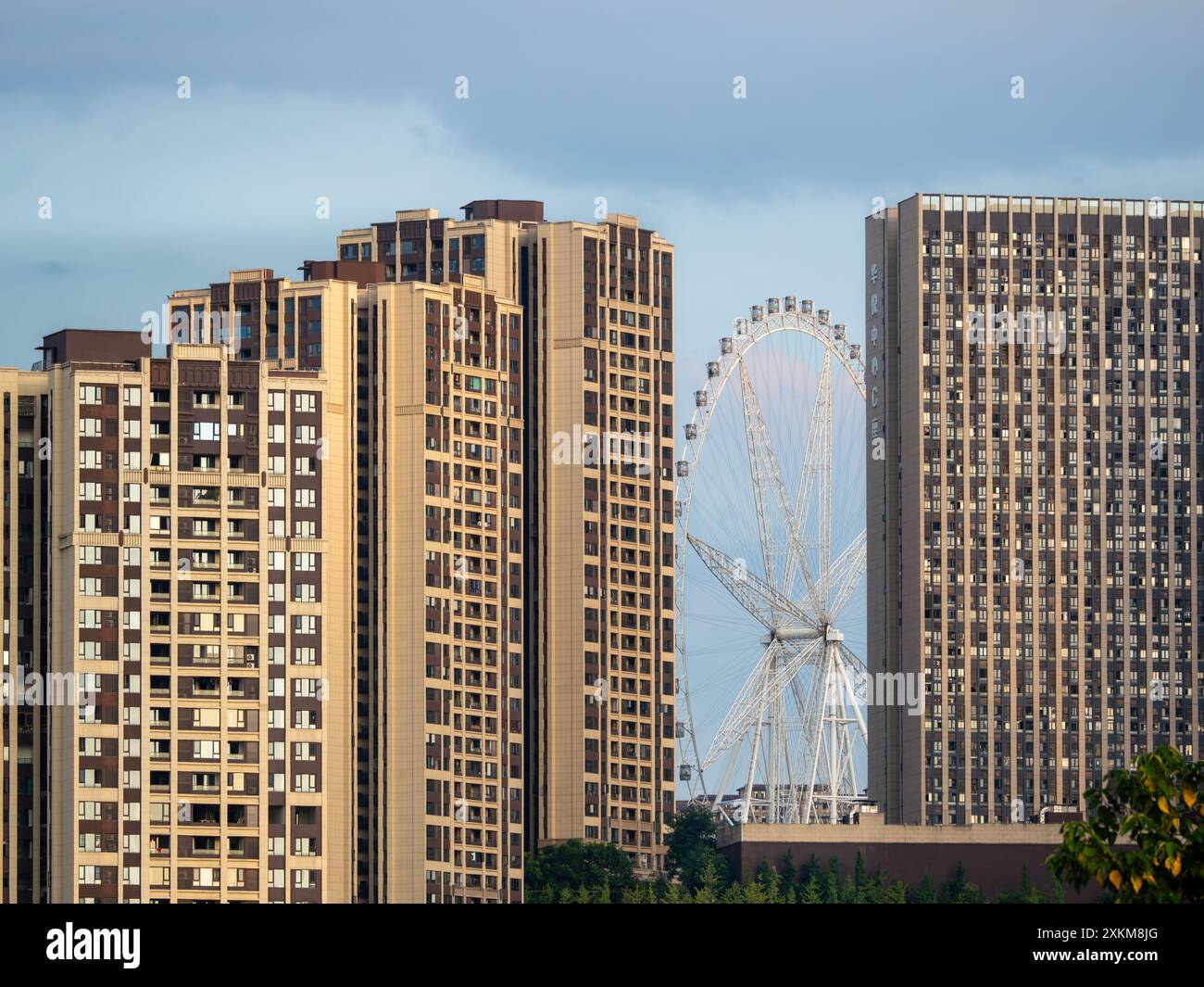 Ferris wheel visible between the gap of two high rise buildings Stock ...