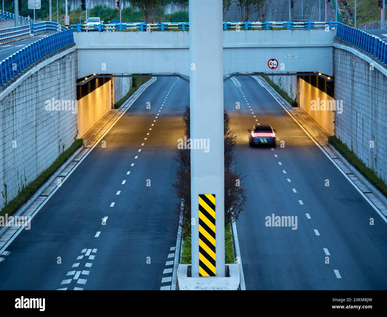 Eye level view of an internchange, the tunnel illuminated with warm ...