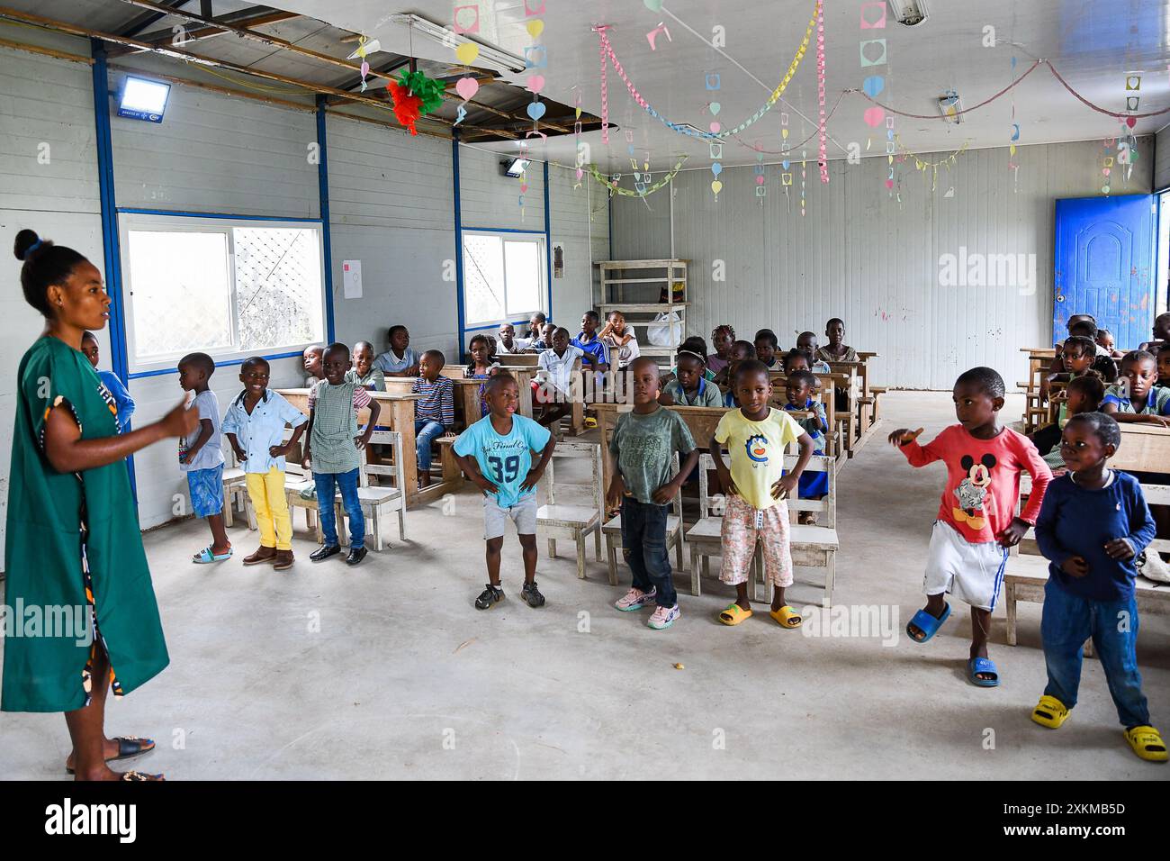 Kribi, Cameroon. 10th July, 2024. A teacher interacts with children at ...
