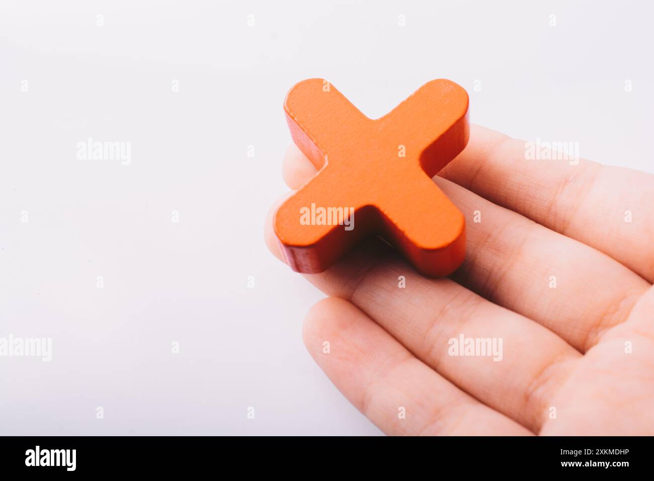 Hand holding letter cube X of made of wood Stock Photo - Alamy