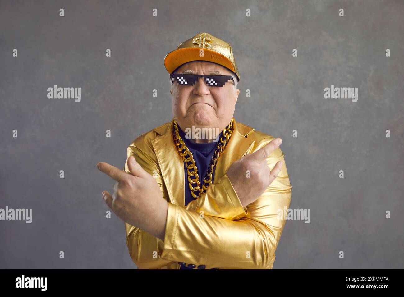 Senior man in a trendy gold jacket and cap with a chain around his neck ...