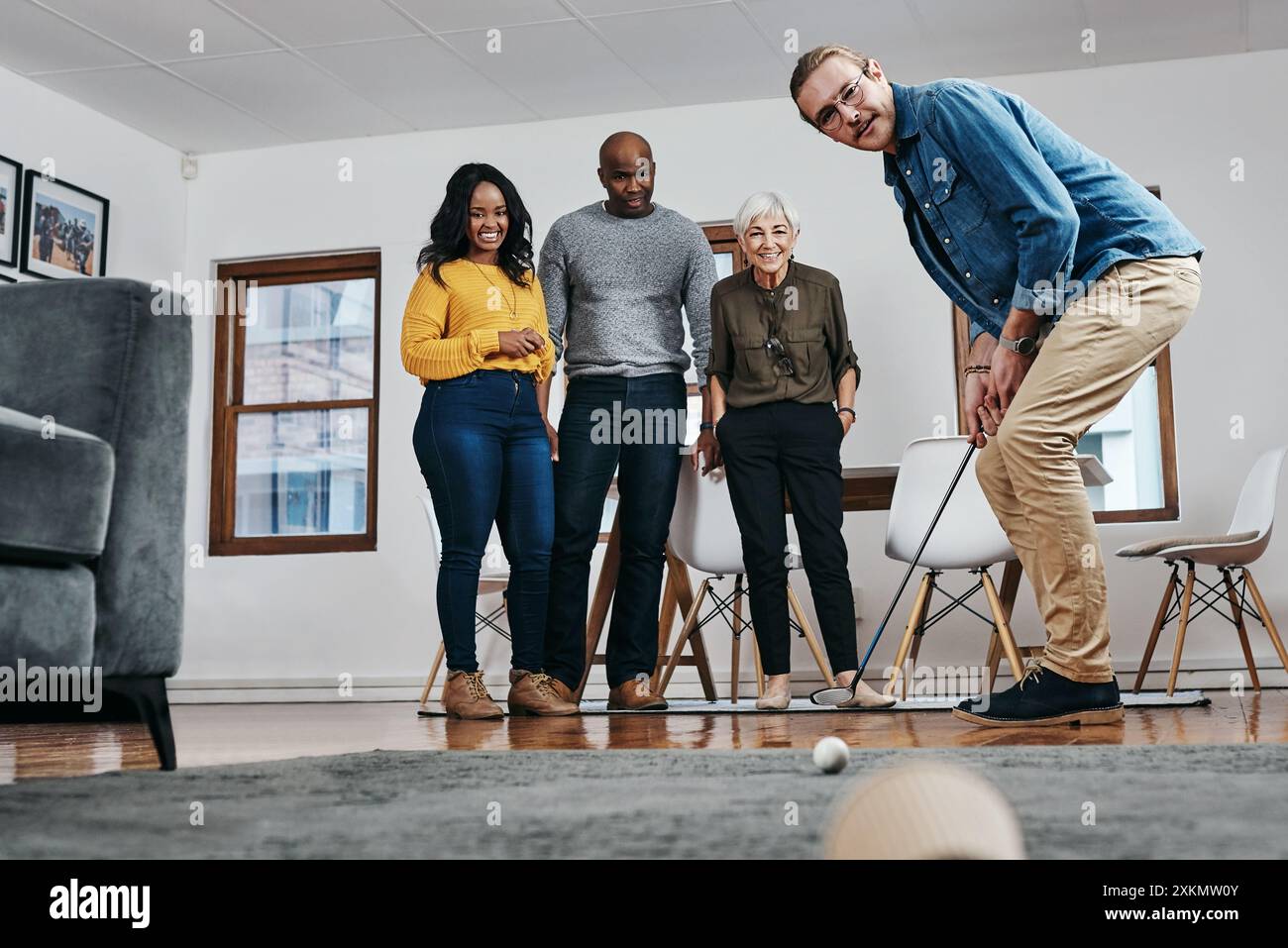 Business people, teamwork and playing golf in office with smile ...