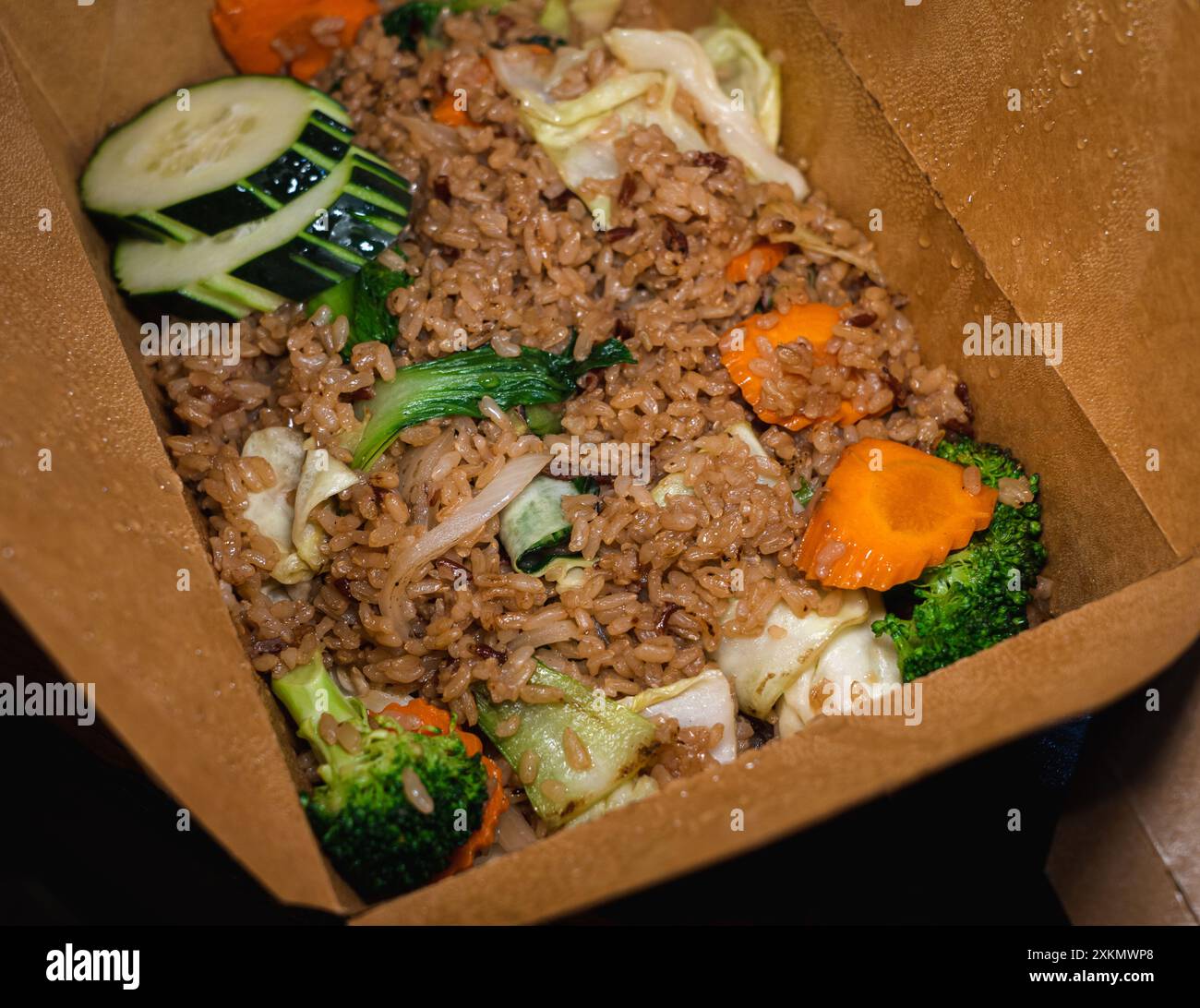 Jasmin fried rice with mixed vegetables in a take out box. Thai food ...