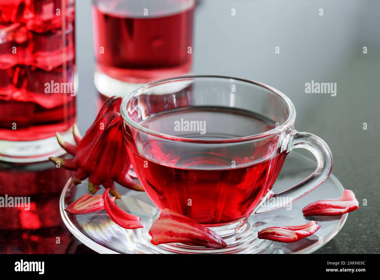 Cup of magenta hibiscus tea (rosella, karkade) on table Stock Photo - Alamy