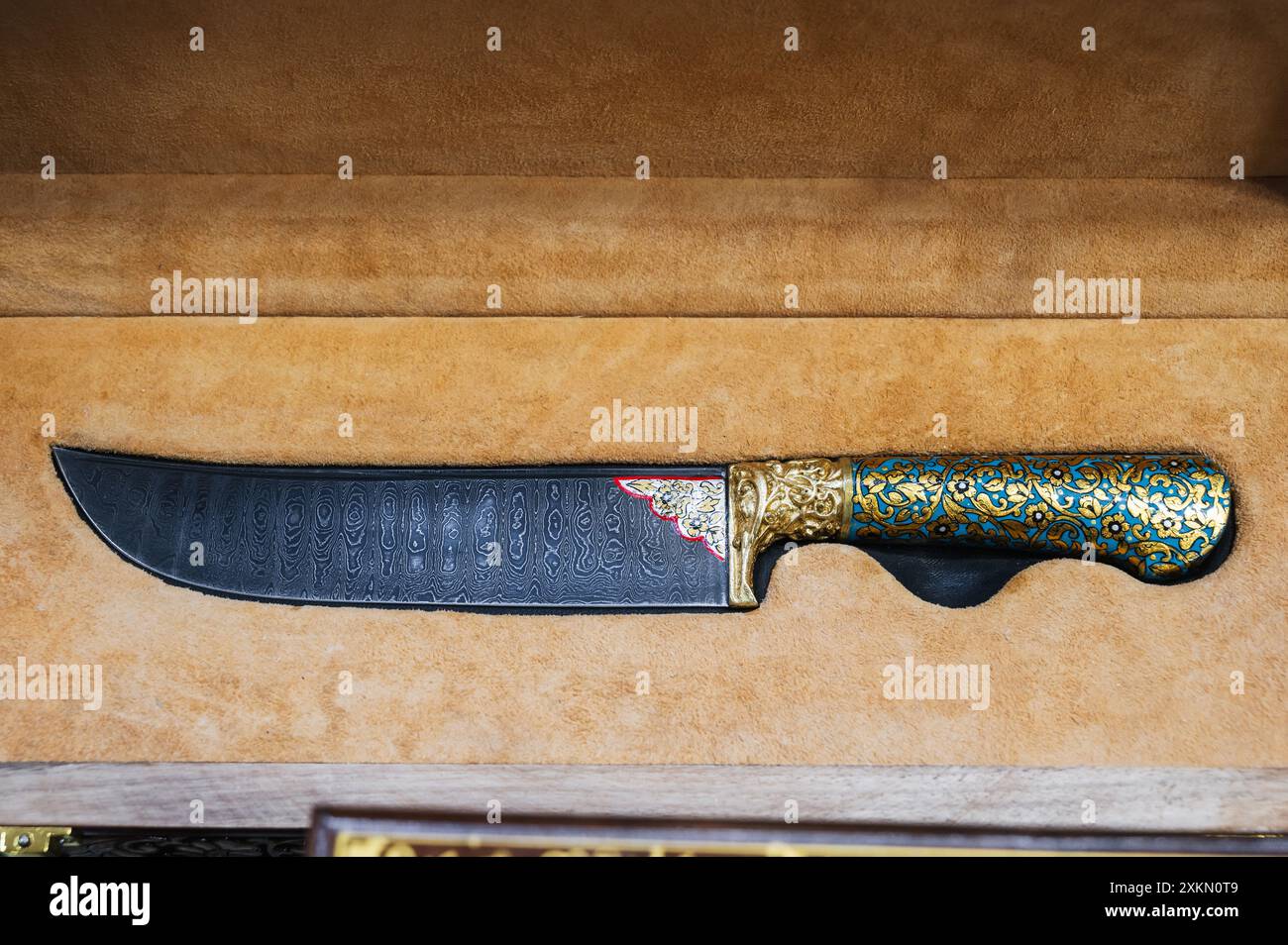 traditional oriental Uzbek knife made of Damascus steel in a wooden gift box in a souvenir shop ...