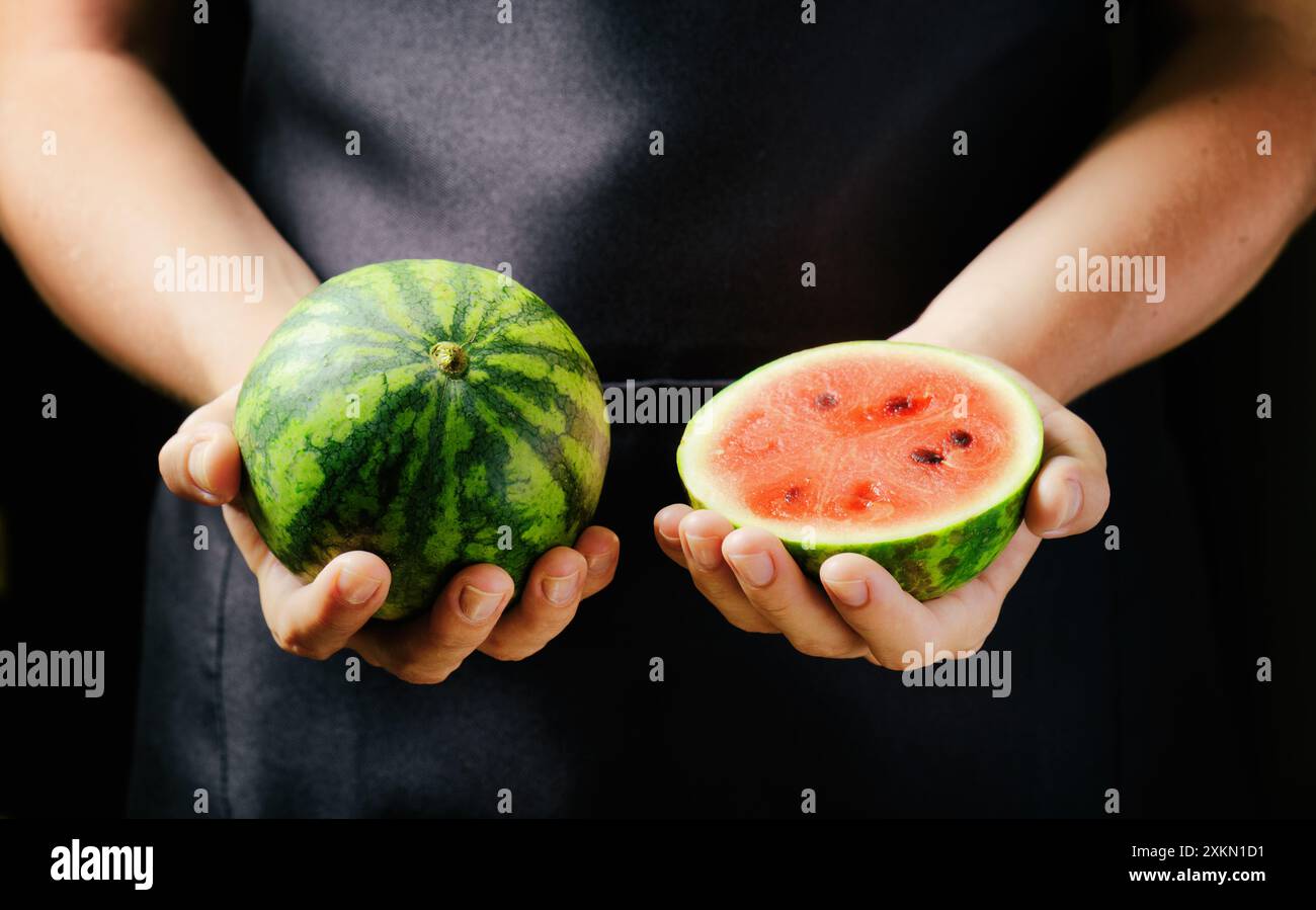 Fresh ripe juicy red small watermelons in hands of woman Stock Photo ...