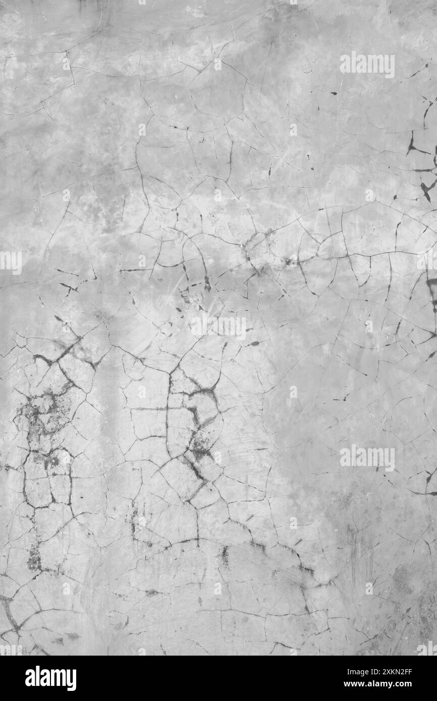 The image is a close up of a wall with cracks and holes in it. The wall ...