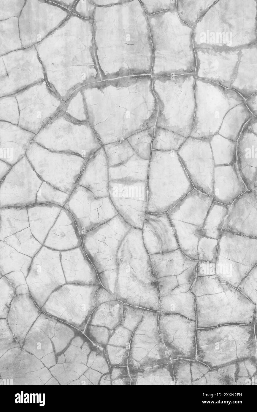 The image is a close up of a wall with cracks and holes in it. The wall ...