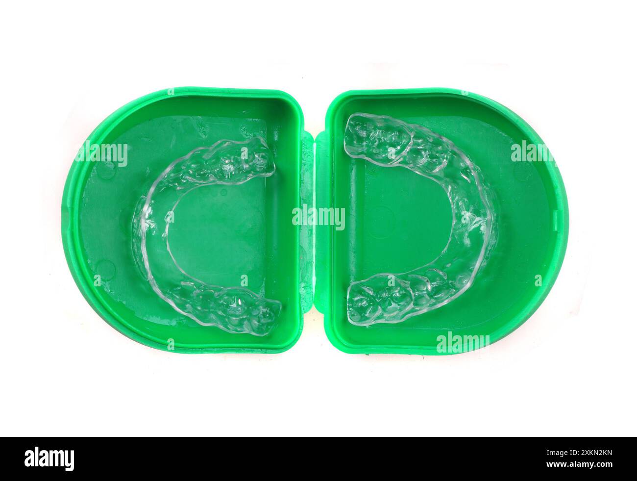 new plastic braces in the green box isolated Stock Photo - Alamy