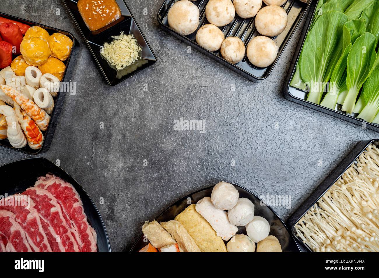A variety of food items are displayed on a table, including meat ...
