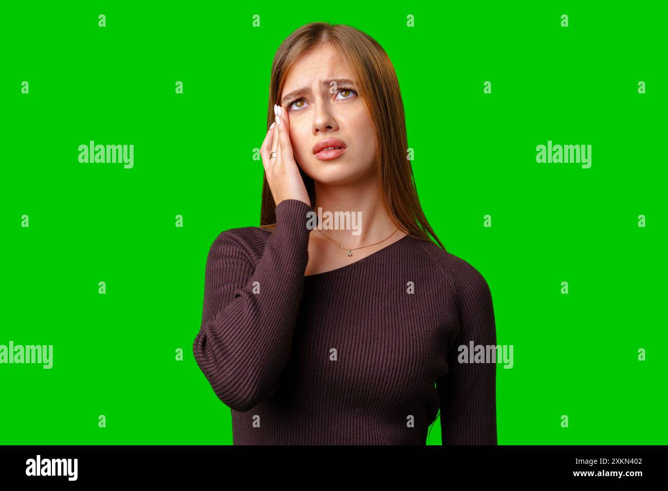 Woman touches forehead wearing hi-res stock photography and images - Alamy