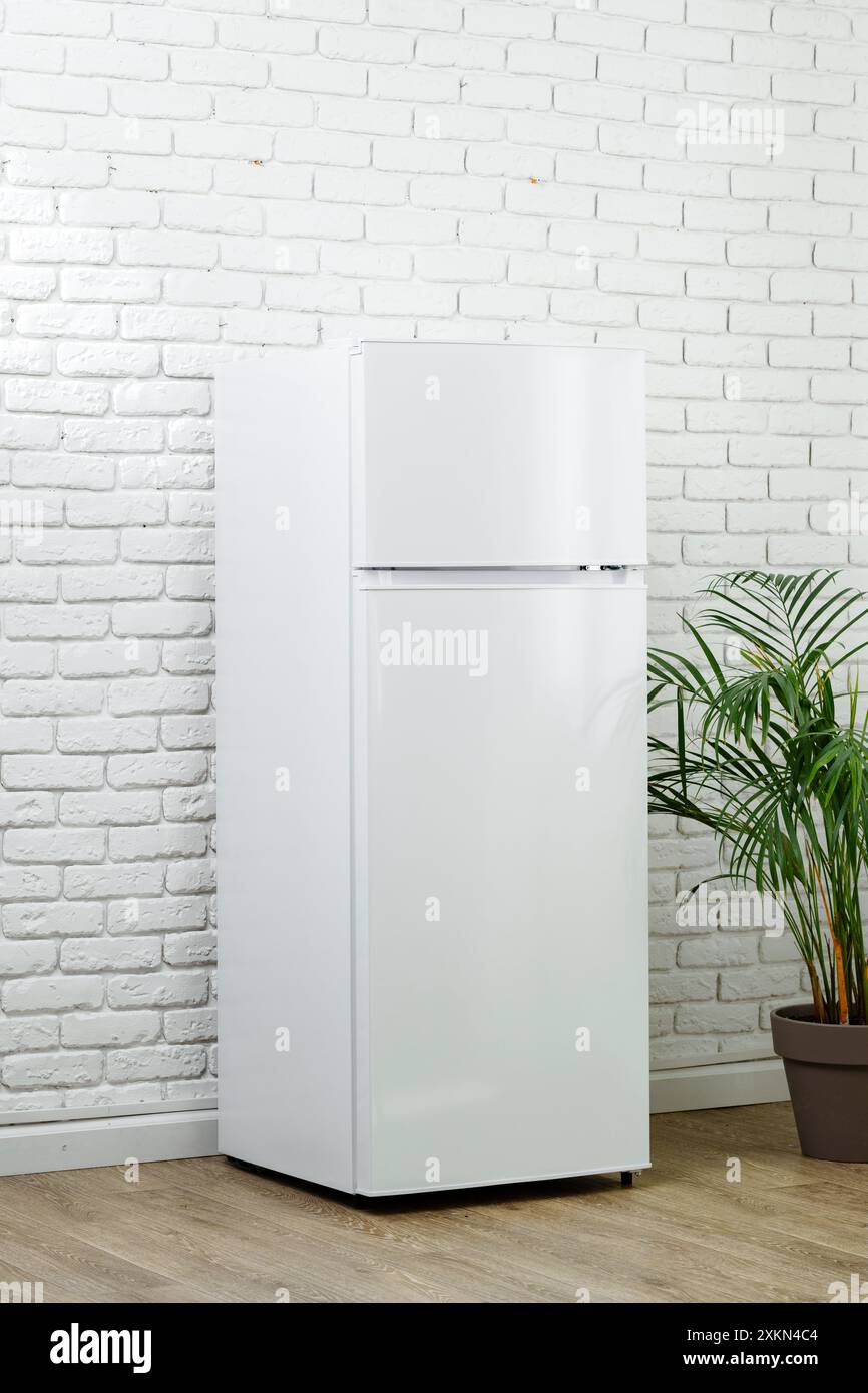White Refrigerator In A Modern Kitchen With Brick Wall Stock Photo - Alamy