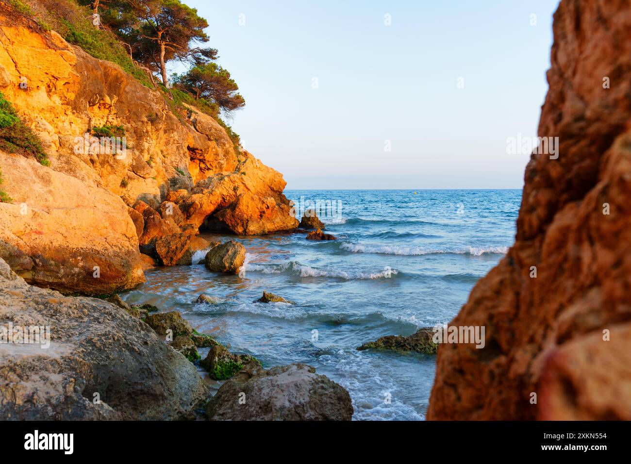 Vibrant coastal cliffs meet calm waters, creating an idyllic scene. The ...