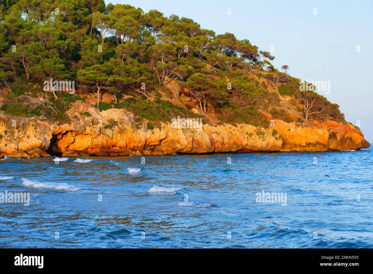 Stunning coastal cliffs adorned with lush greenery meet the vibrant ...