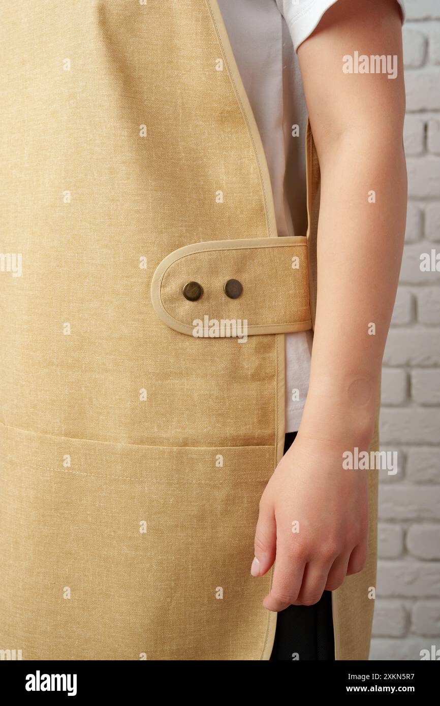 Close Up of Tan Canvas Apron With Metal Eyelet Detail Stock Photo - Alamy