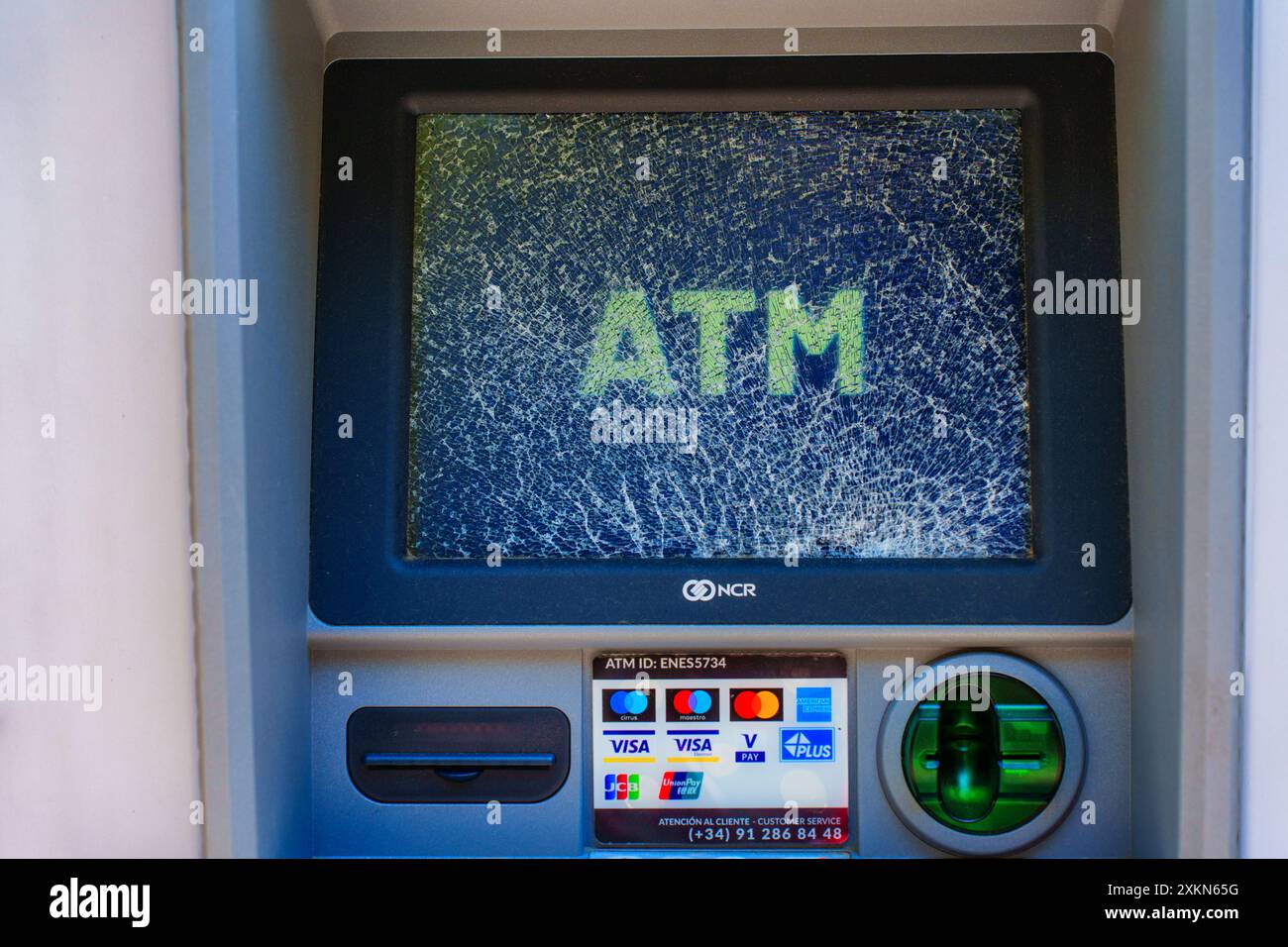Barcelona, Spain - July 16, 2024: ATM screen with broken glass showing faded 'ATM' text Stock ...