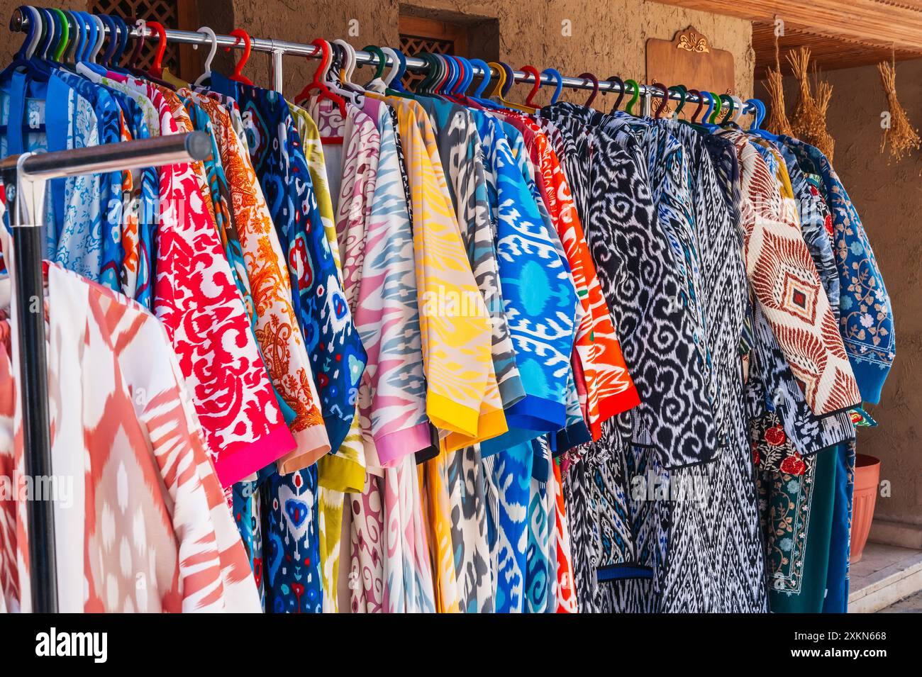 Turkish silk dresses with a bright colorful pattern in oriental street ...