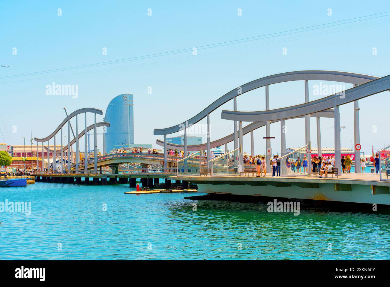 Barcelona, Spain - July 16, 2024: Contemporary bridge over marina with ...