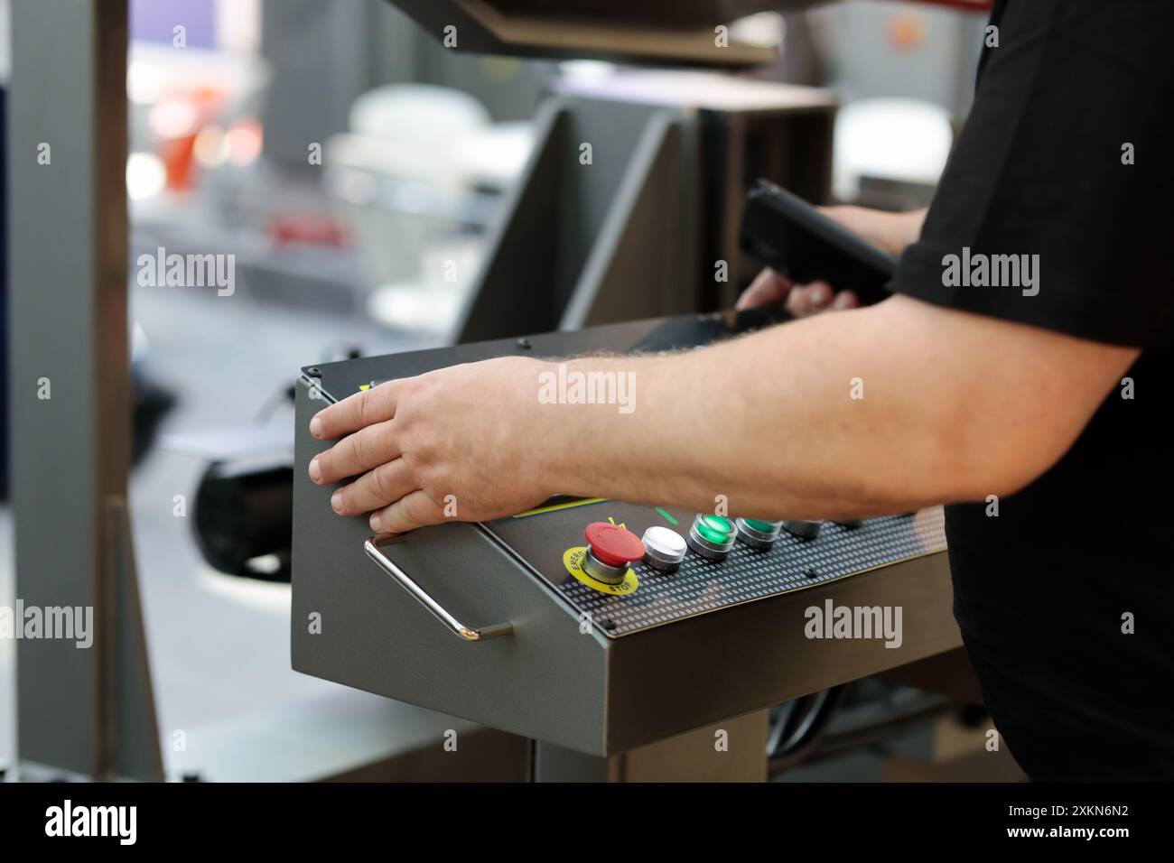 Band saw machine operator at the control console. Selective focus Stock ...