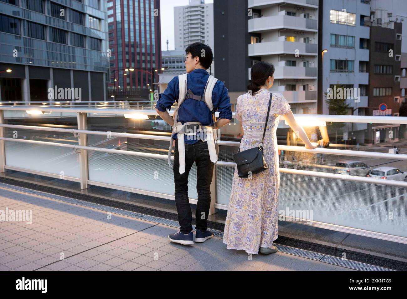 Tokyo, Japan. 20th July, 2024. Young parents stand with their baby on a ...