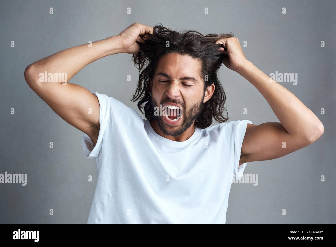 Studio, man and screaming with pulling of hair for bad news, anxiety ...