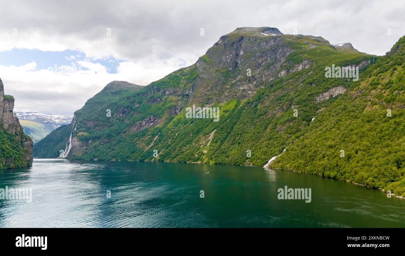 A stunning view of a deep Norwegian fjord, surrounded by towering green ...