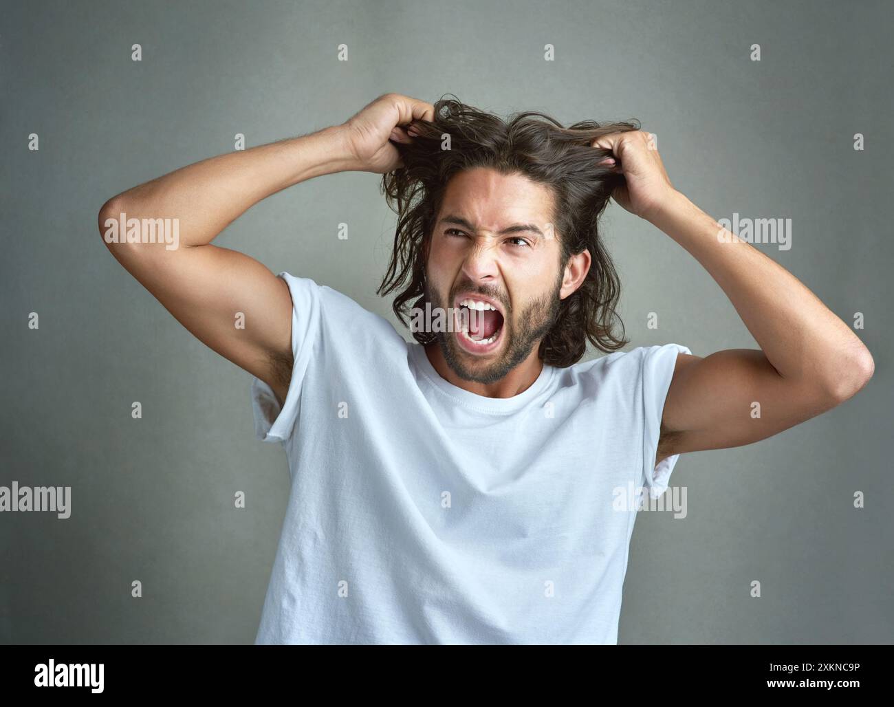 Studio, man and angry with pulling of hair for bad news, stress and ...