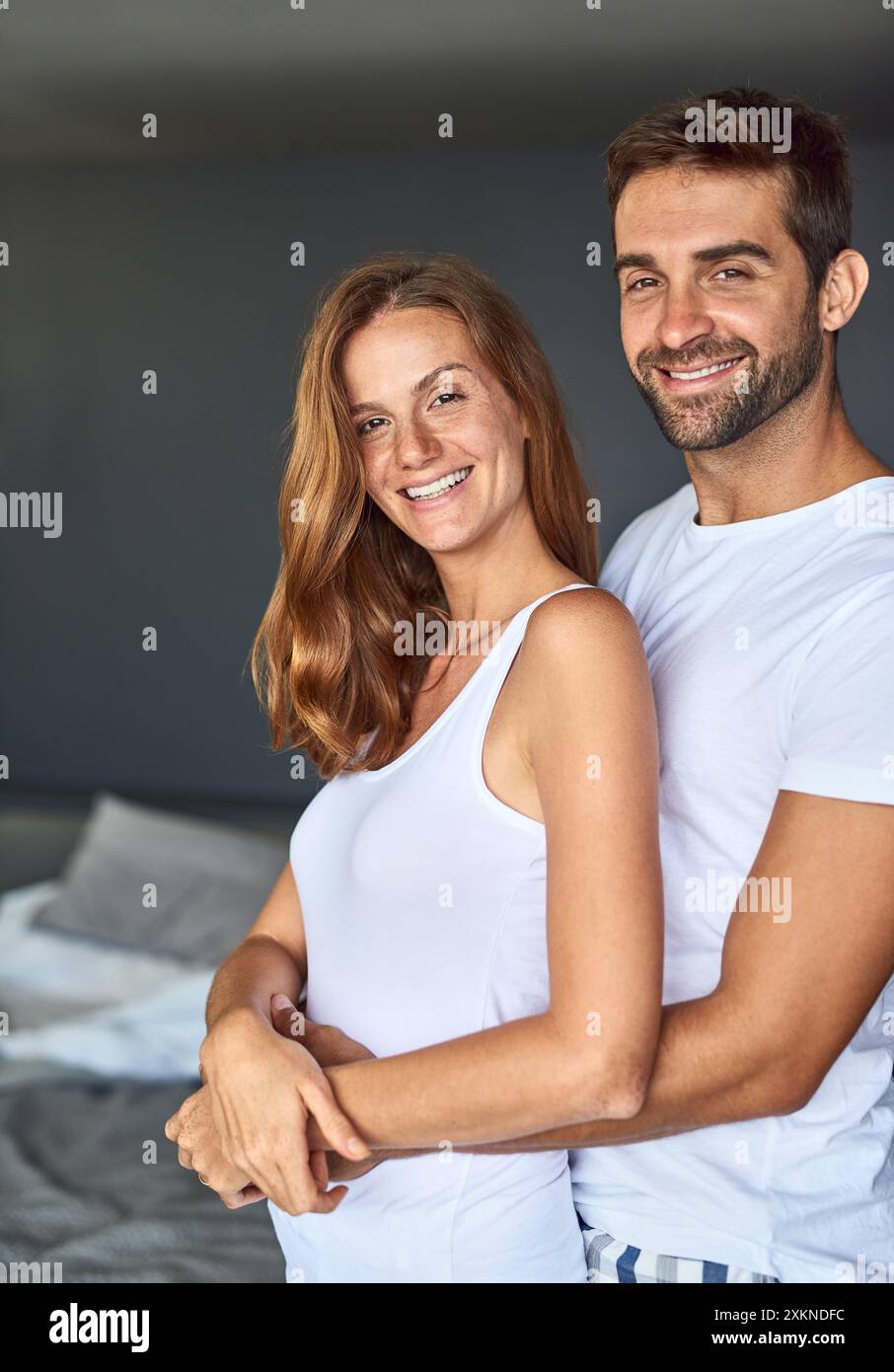 Portrait, smile and couple hug in bedroom for love, care and bonding ...