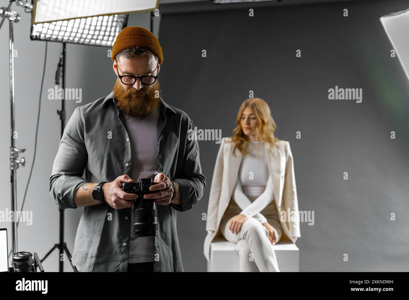 Photographer is making adjustments to the camera while working with a ...