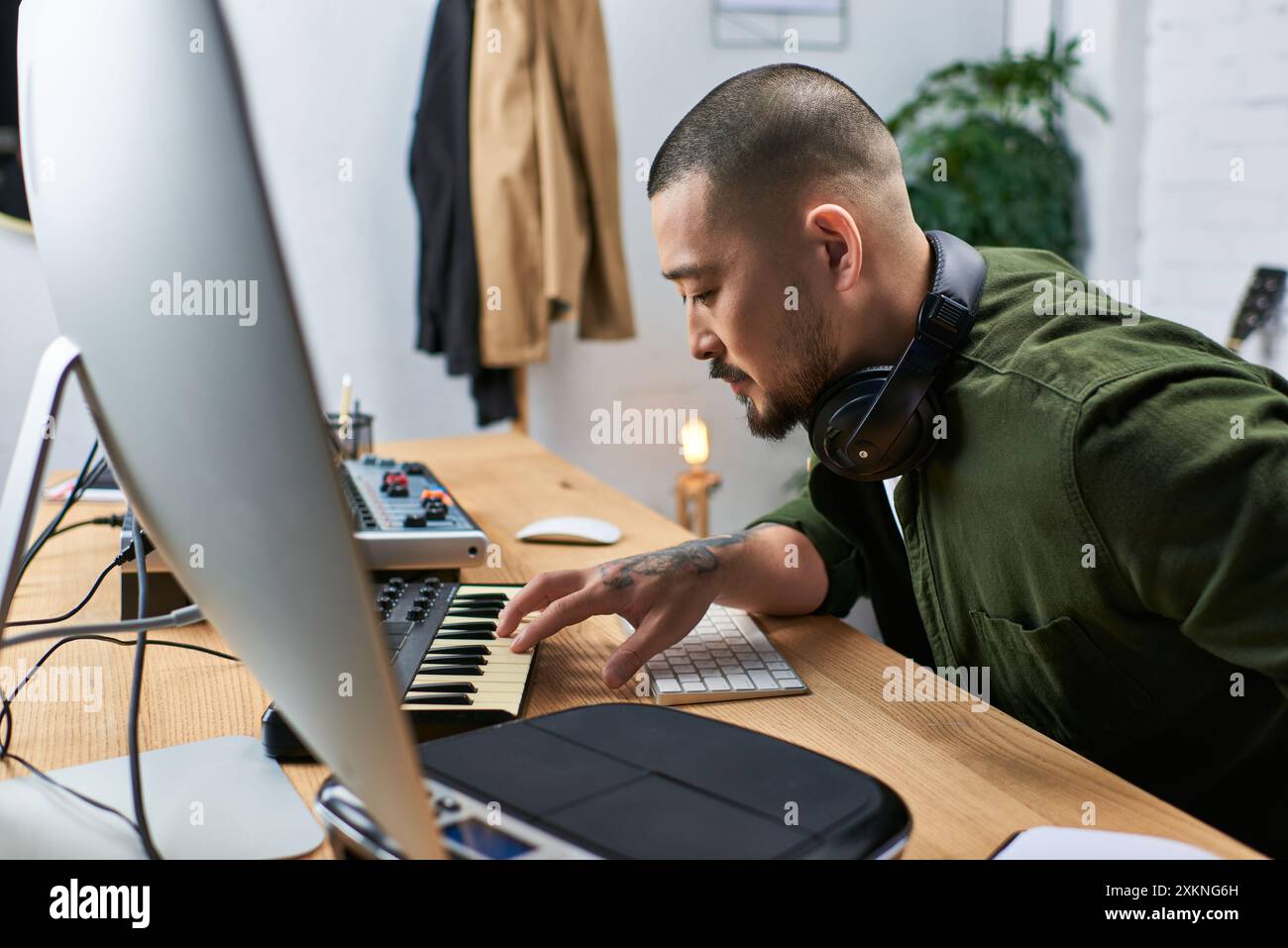 A handsome Asian man, a multi-instrumentalist, is seen in his studio ...