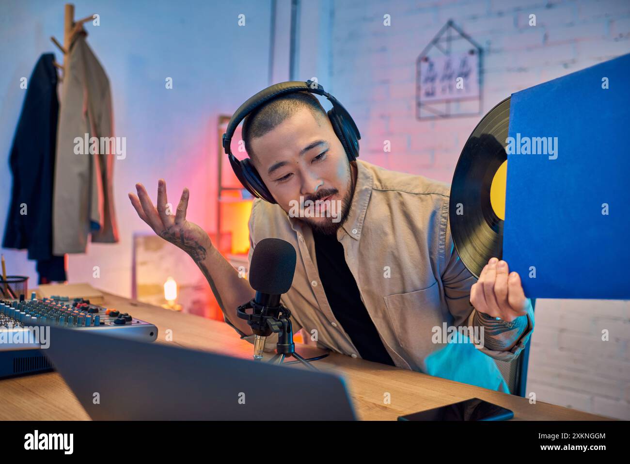 A man in a home studio setup with a microphone and a record Stock Photo ...