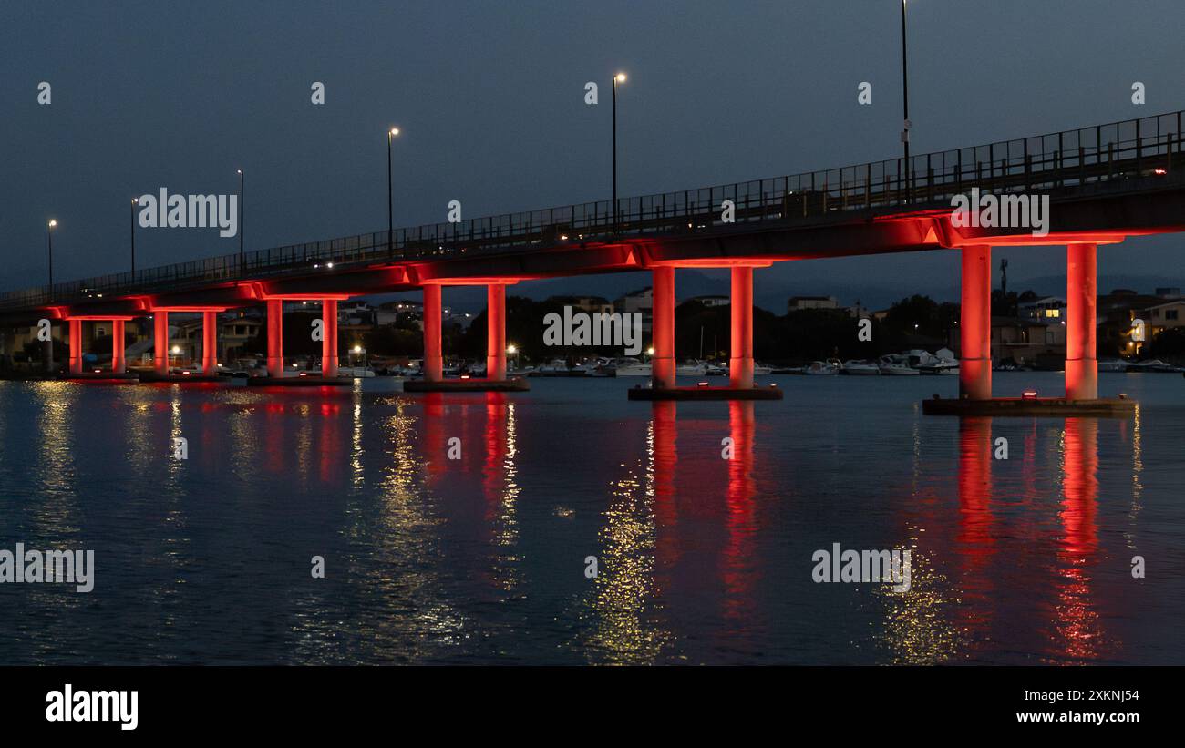 Bridge lit up red in Olbia Stock Photo - Alamy