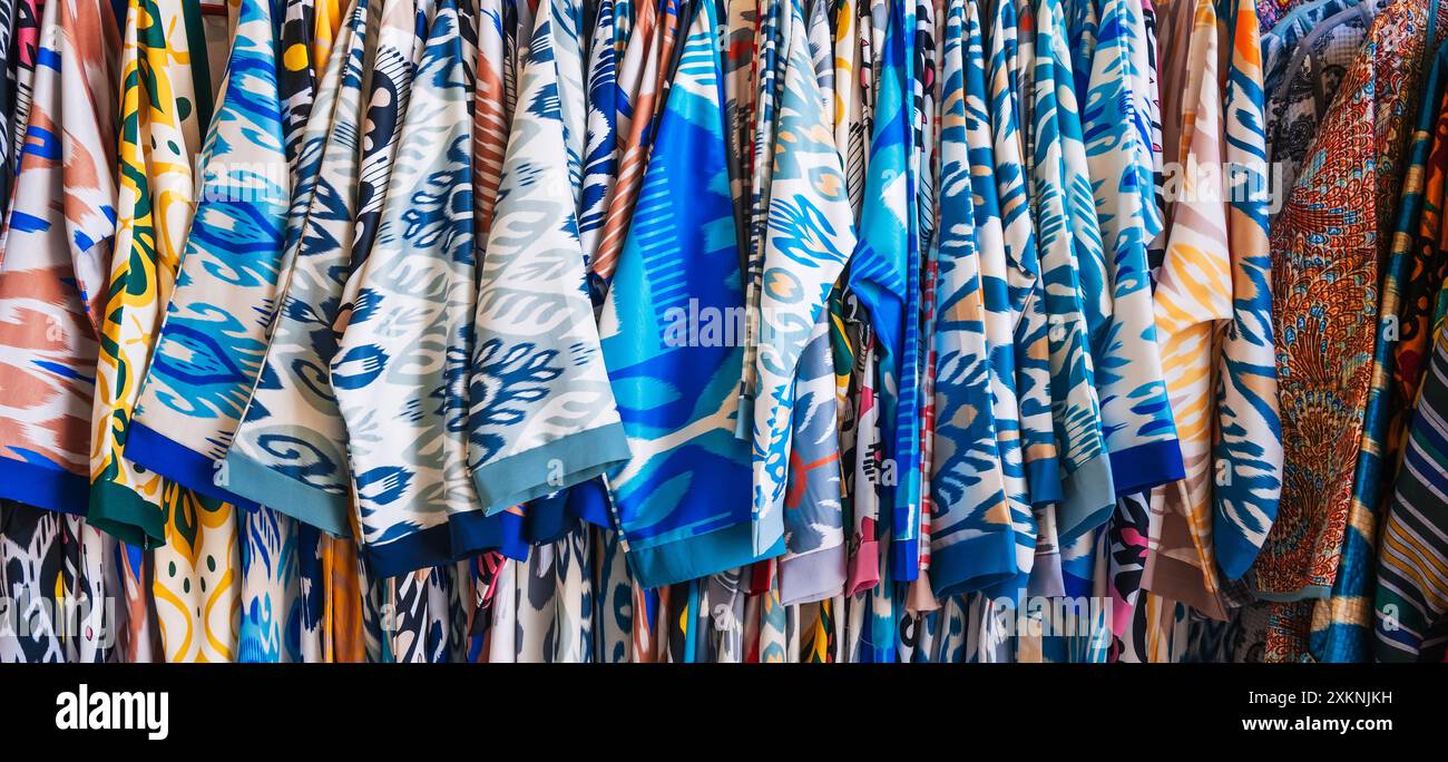 Uzbek dresses made of silk fabric with a bright pattern at oriental ...