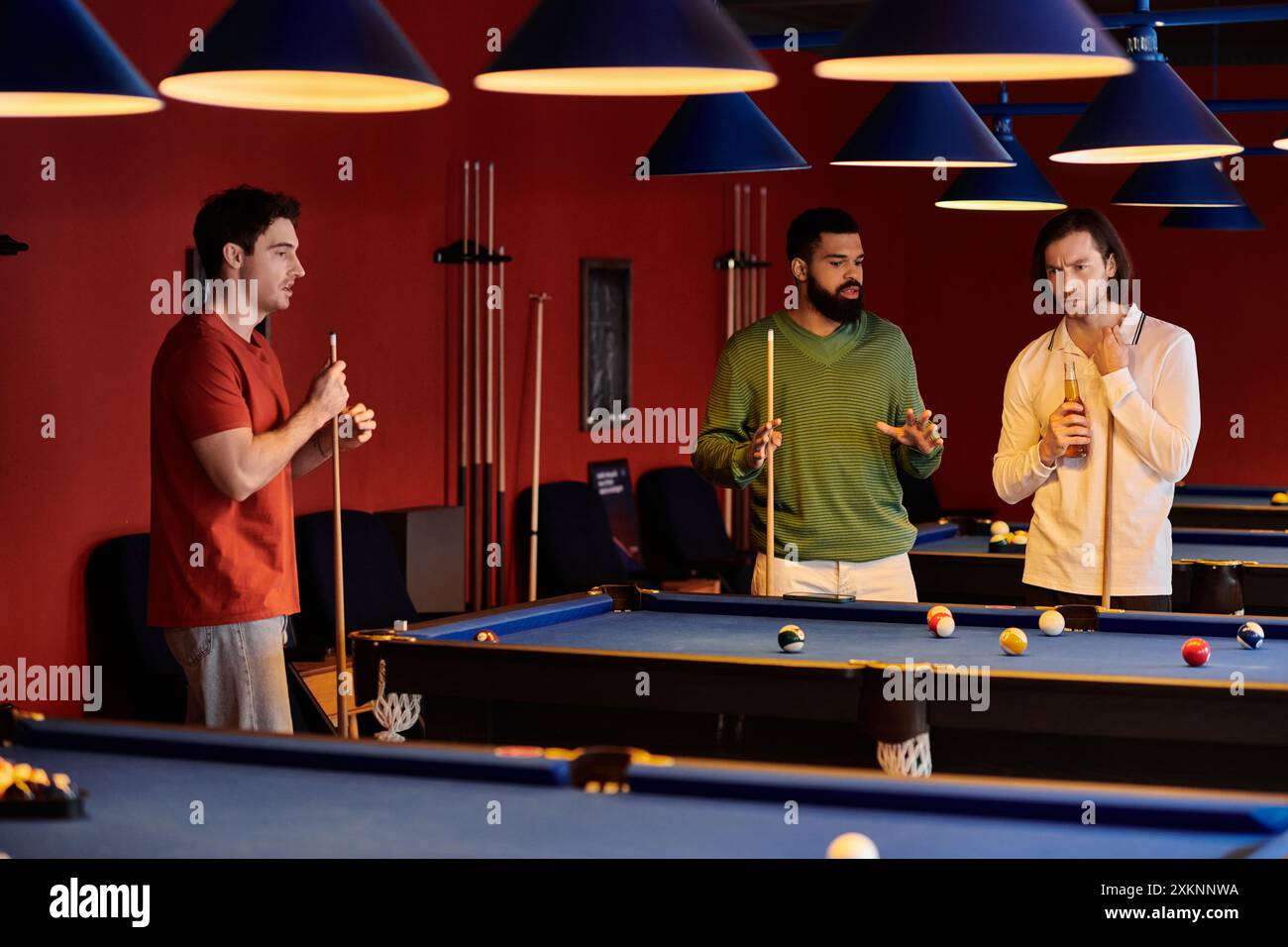 Friends enjoy a casual game of billiards in a dimly lit pool hall Stock ...