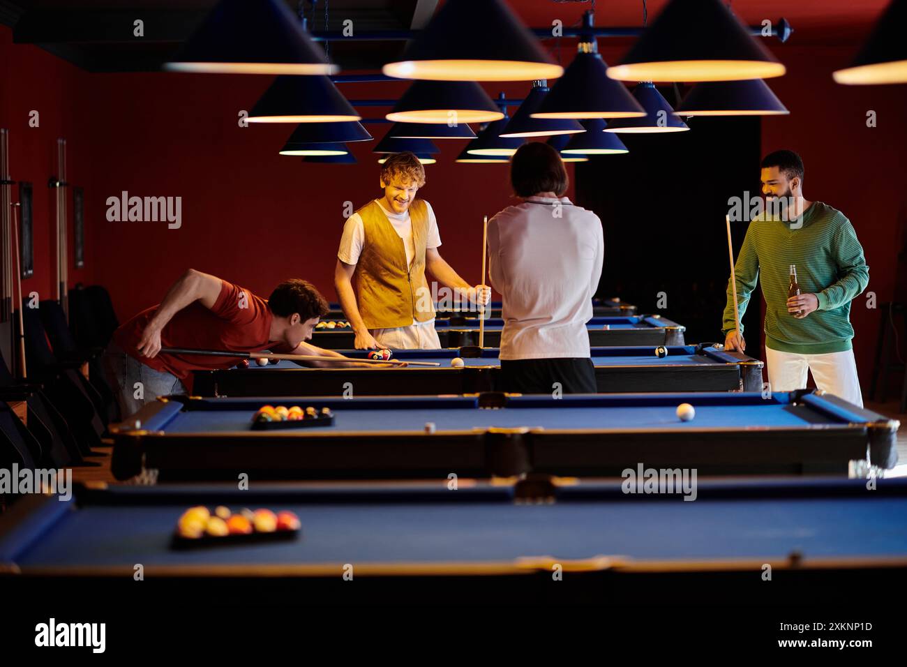 Friends enjoy a casual game of billiards in a dimly lit lounge Stock ...