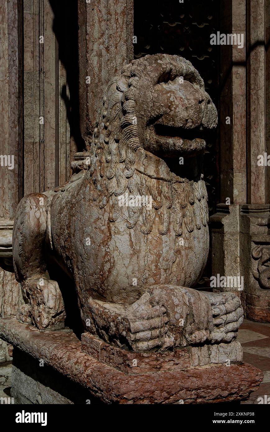 Sculpted lion supports red marble pillar of the Romanesque south-east ...