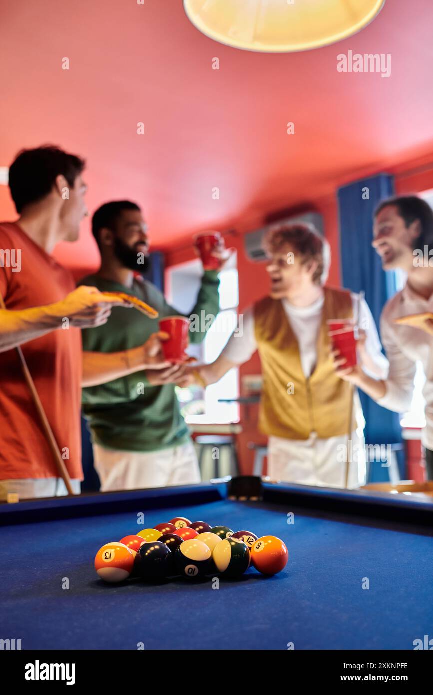 A group of friends laughing and socializing while playing a game of ...