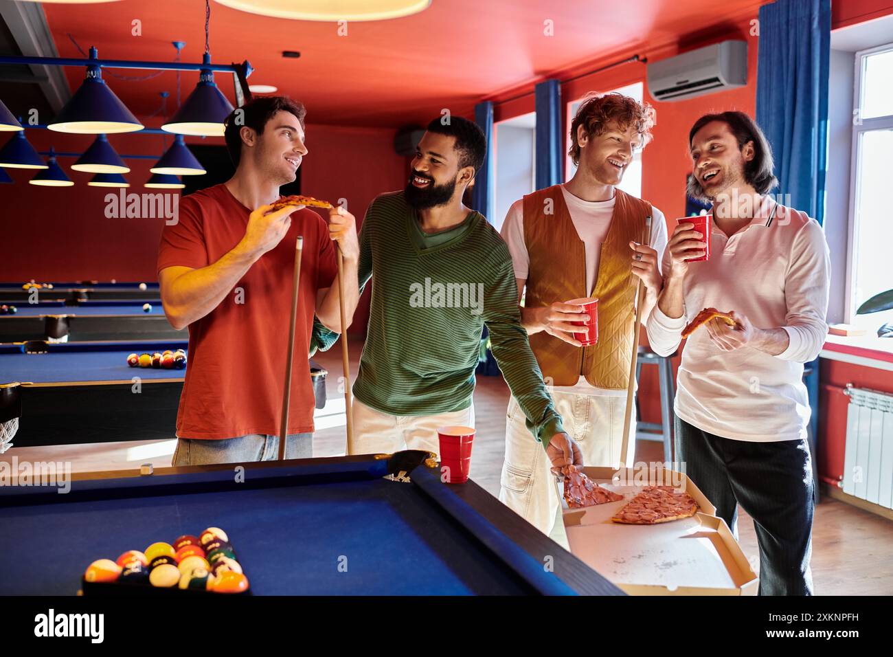 Friends gather around a pool table, enjoying a casual game of billiards ...