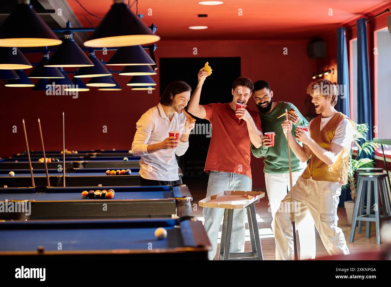 Friends are gathered around a pool table, laughing and enjoying a ...