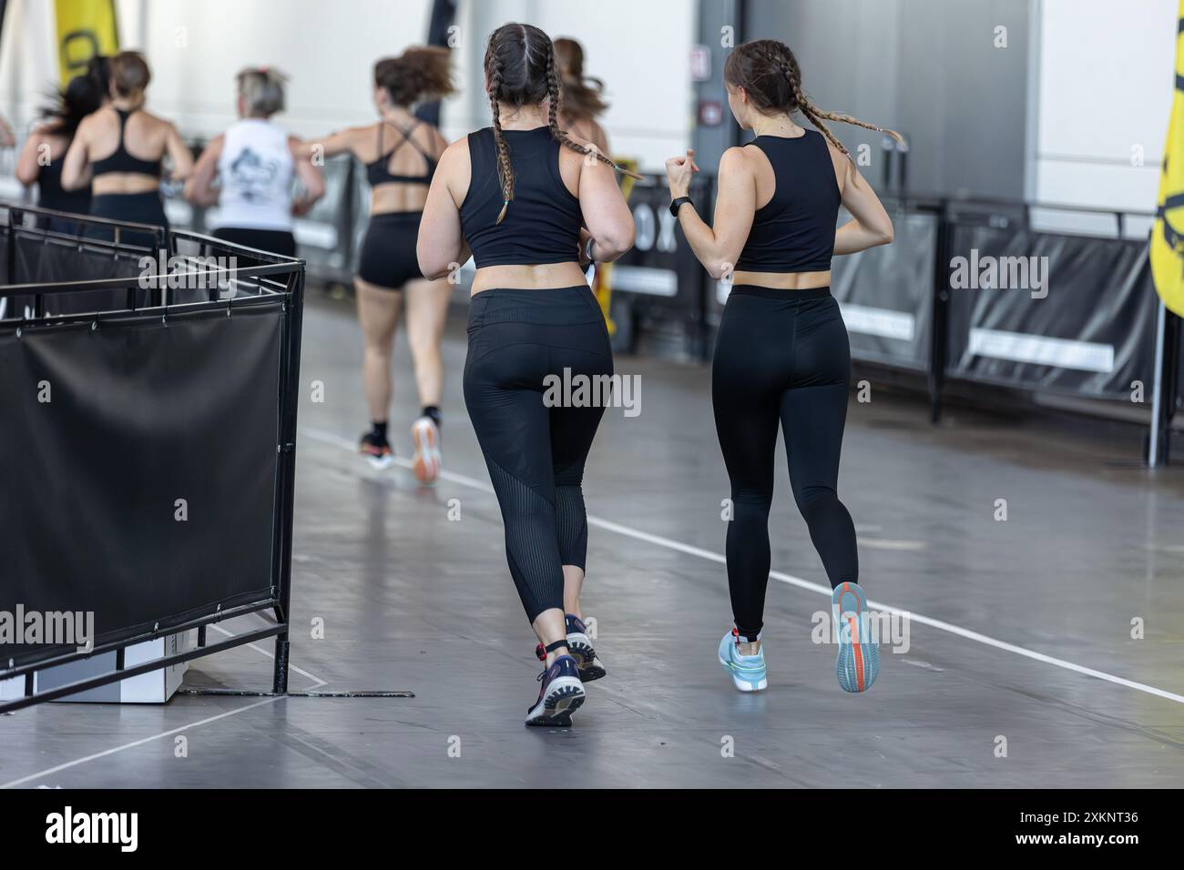 Indoor Marathon - Girls running Together Stock Photo - Alamy