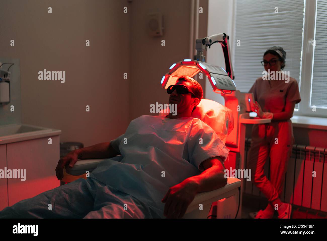 Female trichologist specialist adjusting innovation device for ...