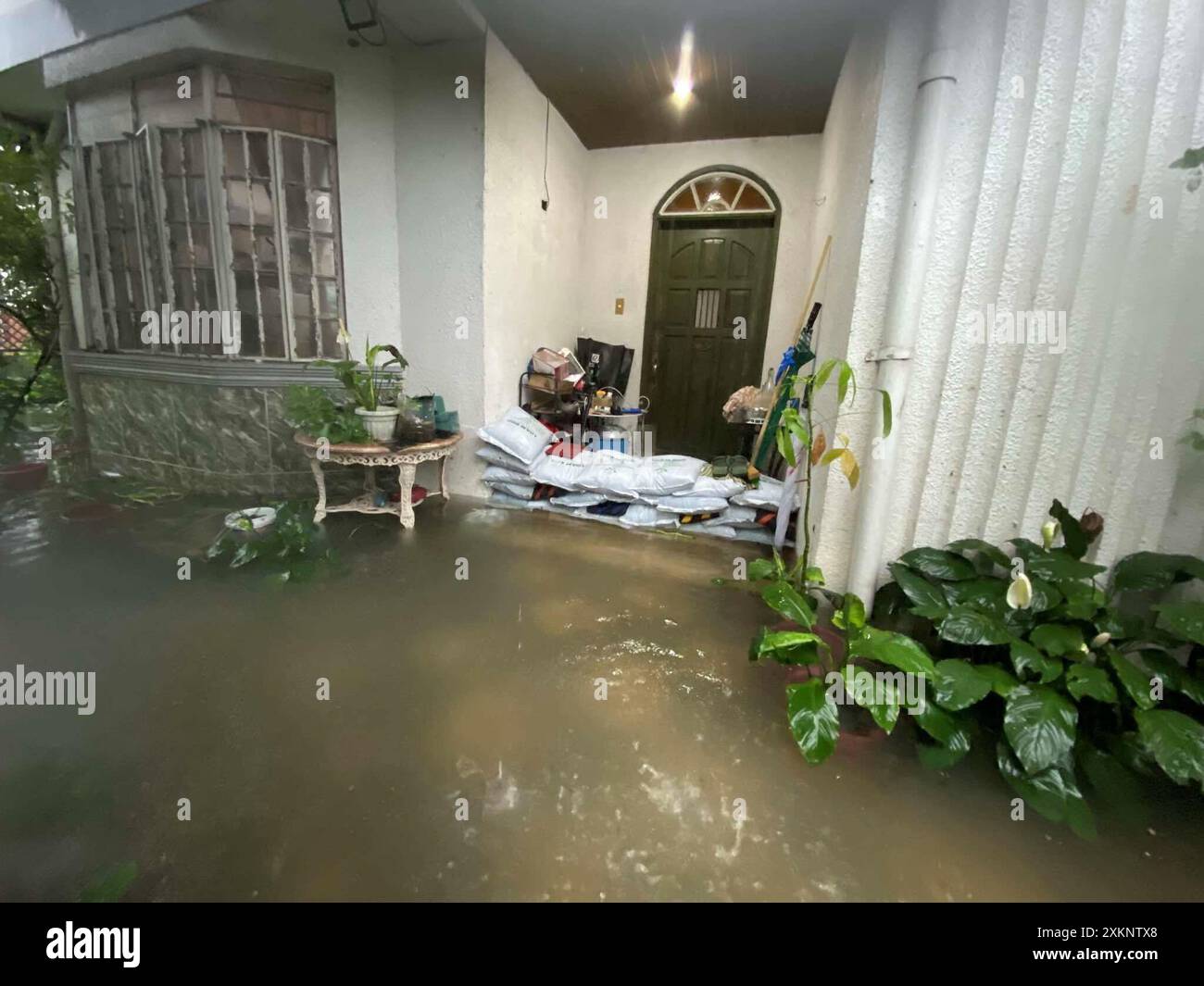 Manila, Philippines. 24th July, 2024. Sandbags lie in front of the door ...