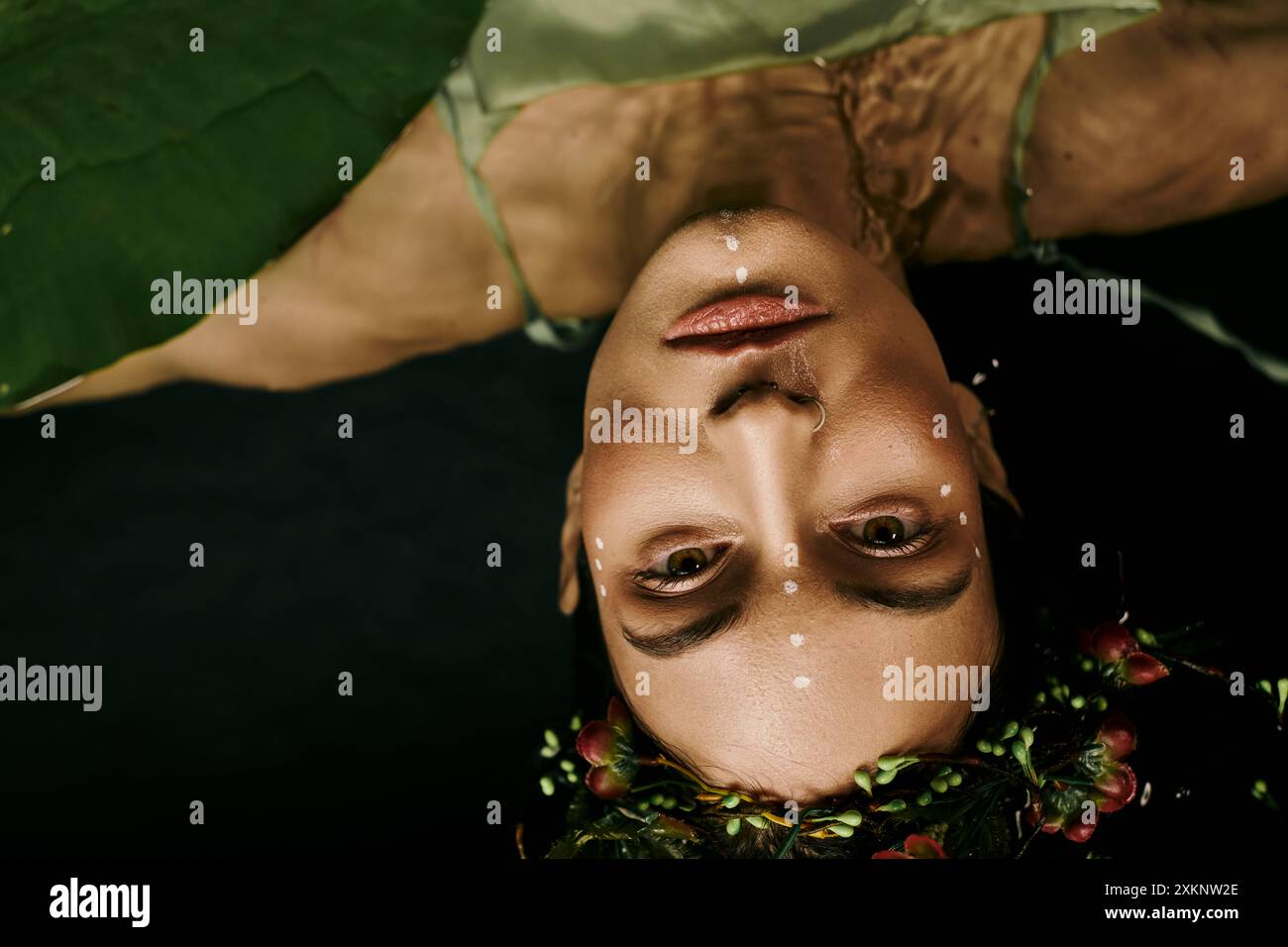 An attractive woman with a floral crown poses in a swamp Stock Photo ...