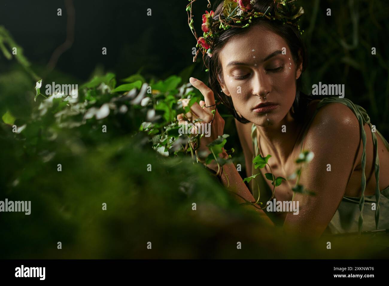 Posing woman in elegant attire with floral crown by swamp Stock Photo ...