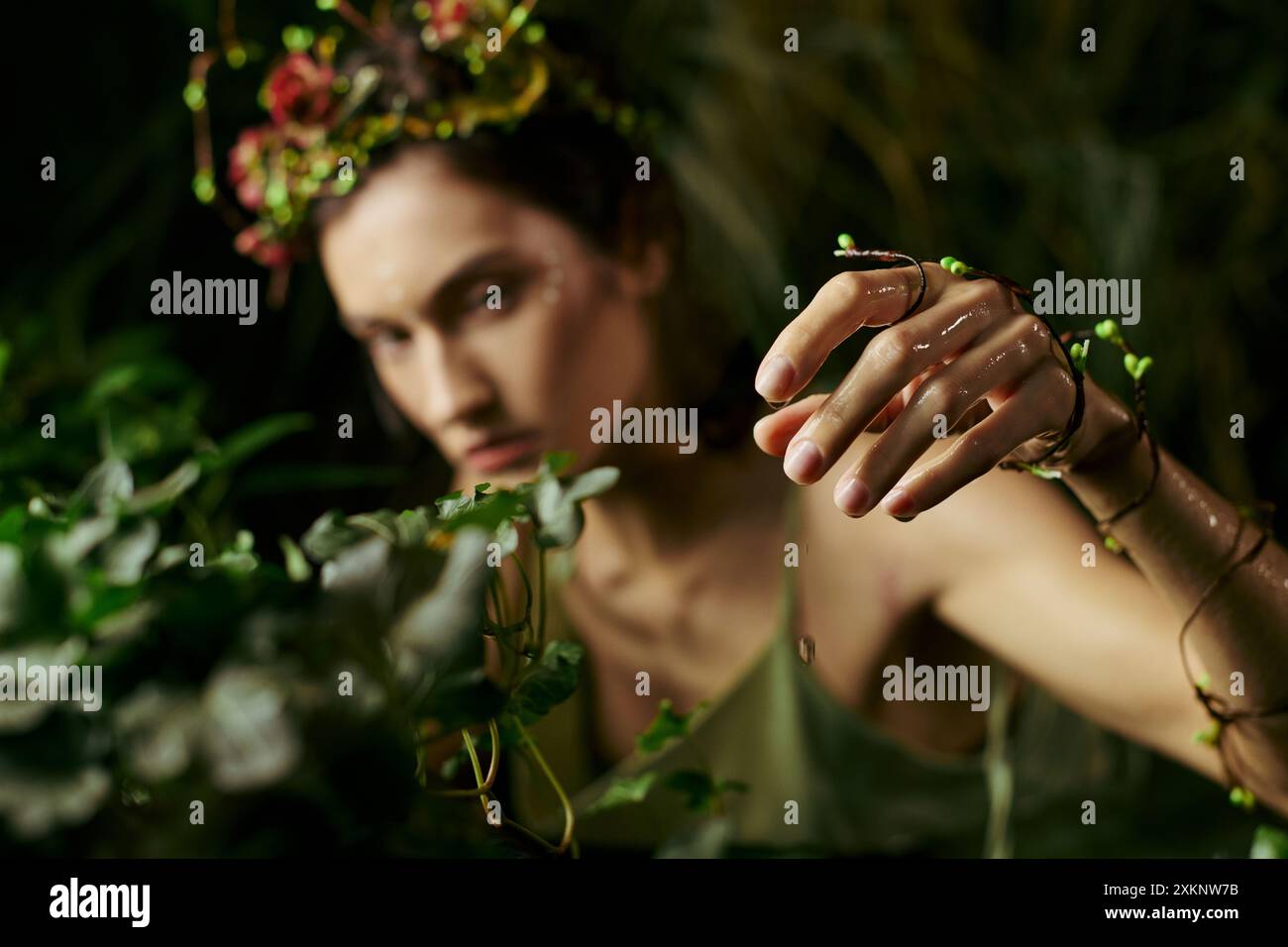 A woman in flowing attire poses near a swamp, her hand reaching out to ...