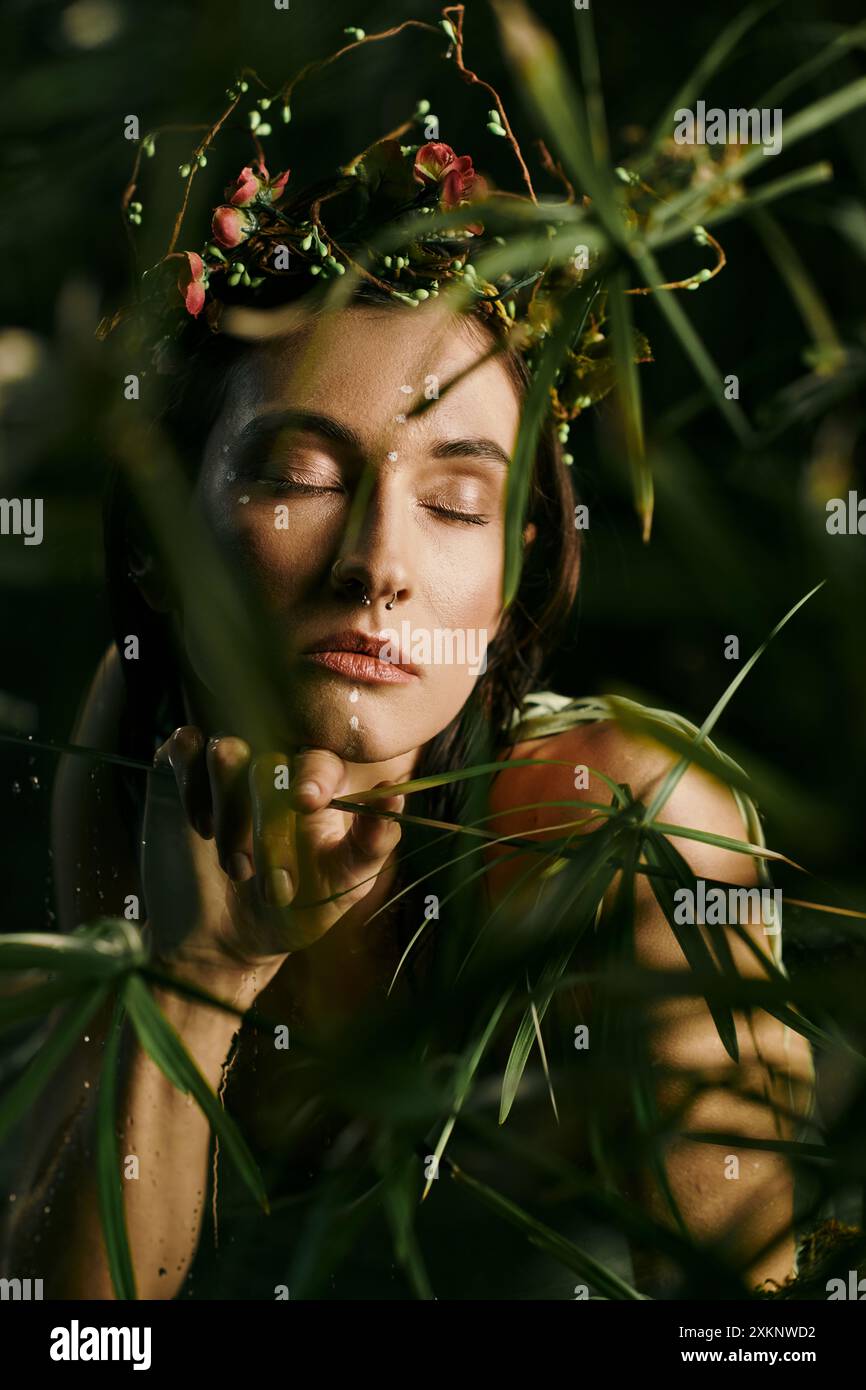 A woman with a flower crown stands in a swamp, eyes closed, surrounded ...
