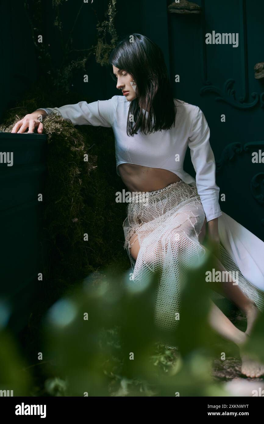 A woman in a white dress poses near a swamp Stock Photo - Alamy