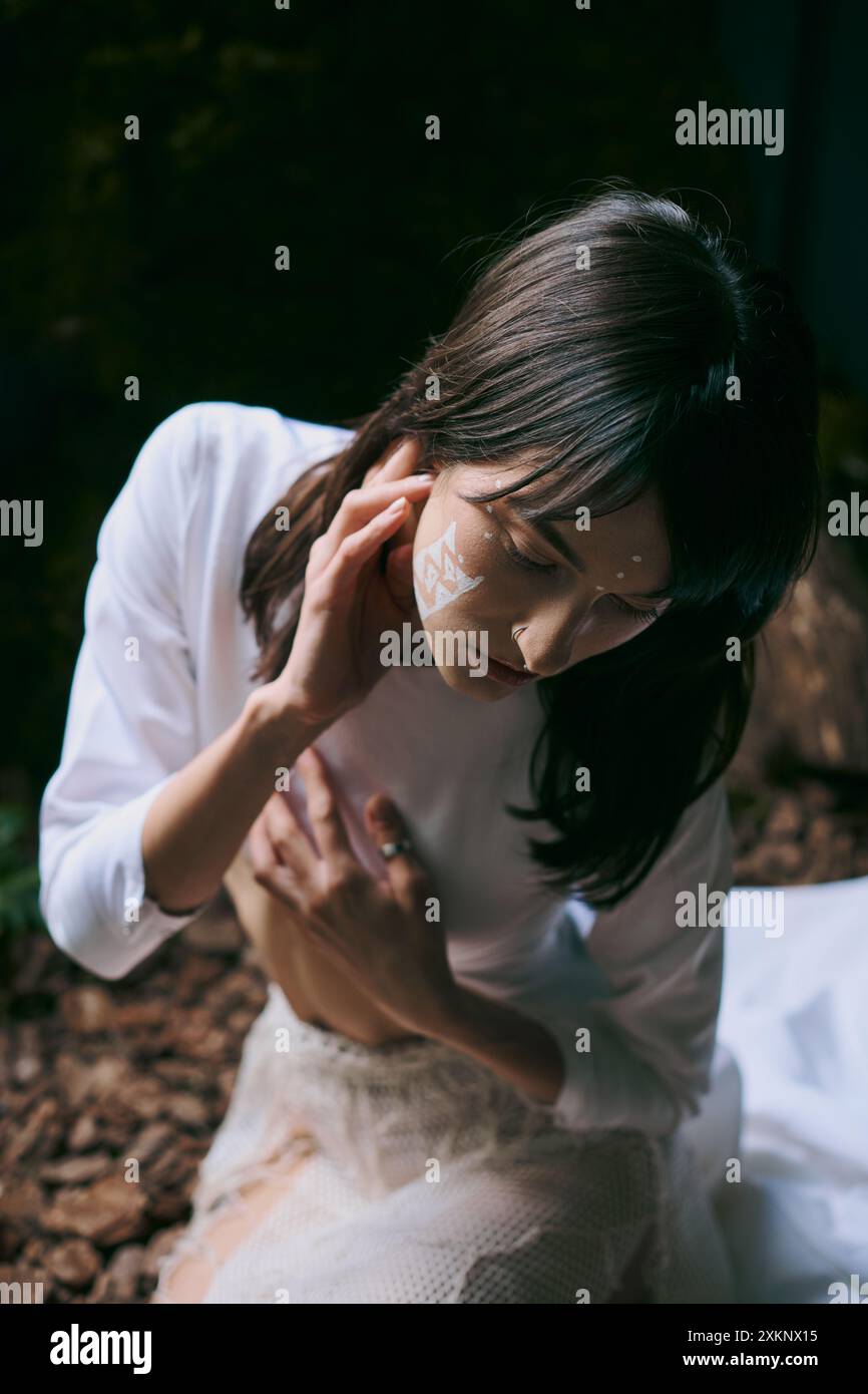 A woman in white clothing poses near a swamp Stock Photo - Alamy