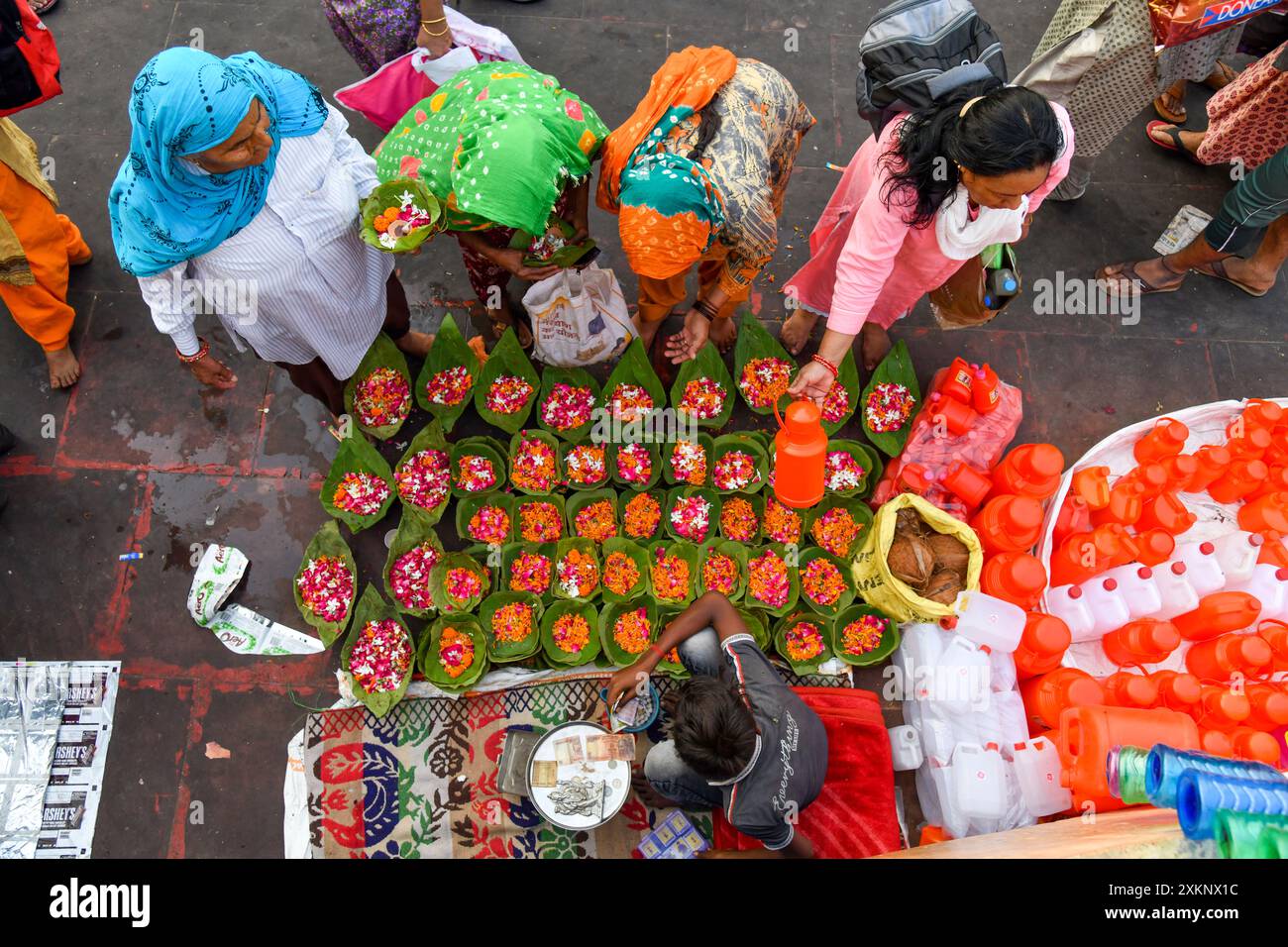 Flowers arranged in a leaf baskets are floated in the river ganges by ...